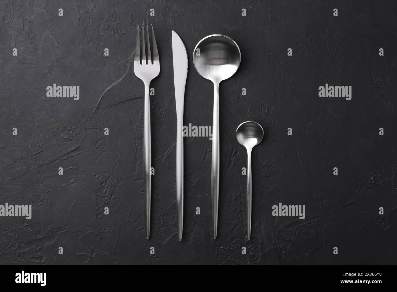 Beautiful cutlery set on black table, flat lay Stock Photo - Alamy