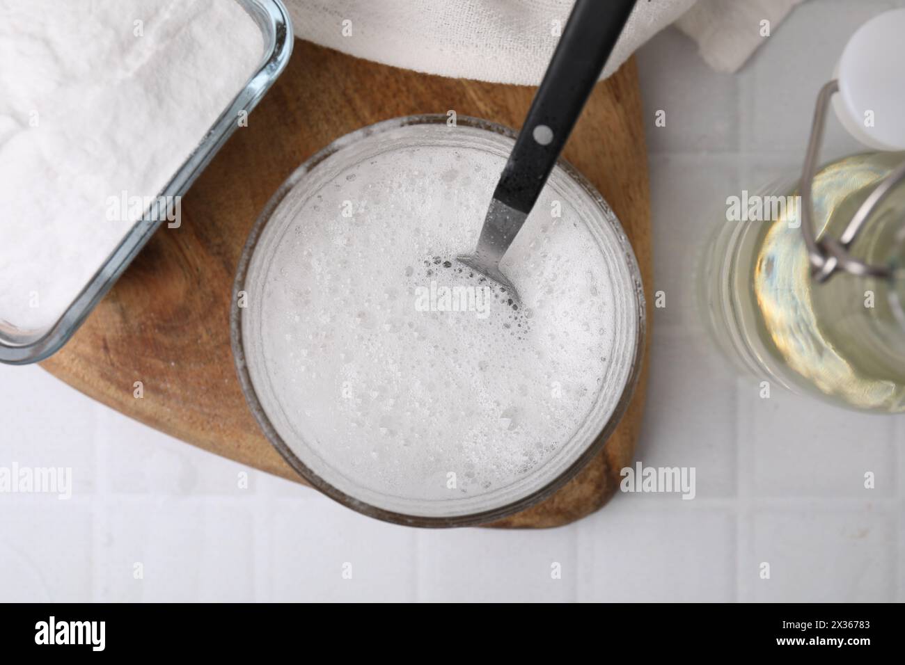 Chemical reaction of vinegar and baking soda in glass bowl on white ...