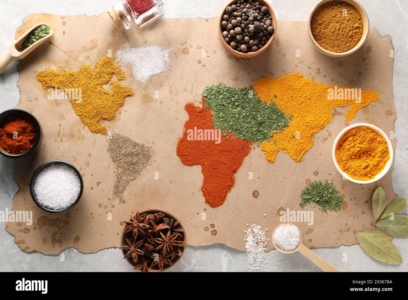 World map of different spices and products on light grey marble table ...