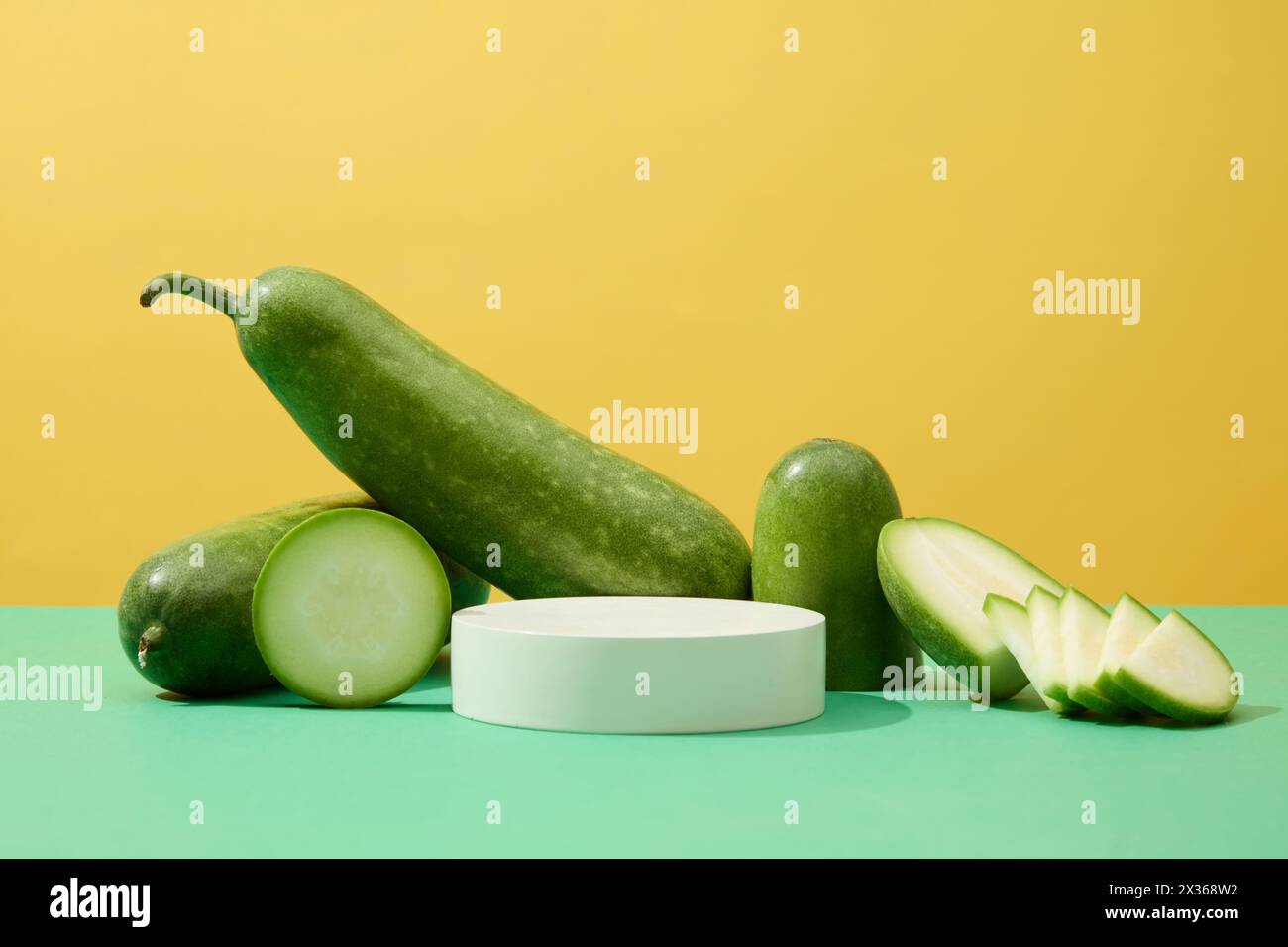 A podium in round shaped decorated with winter melon slices. Front view ...