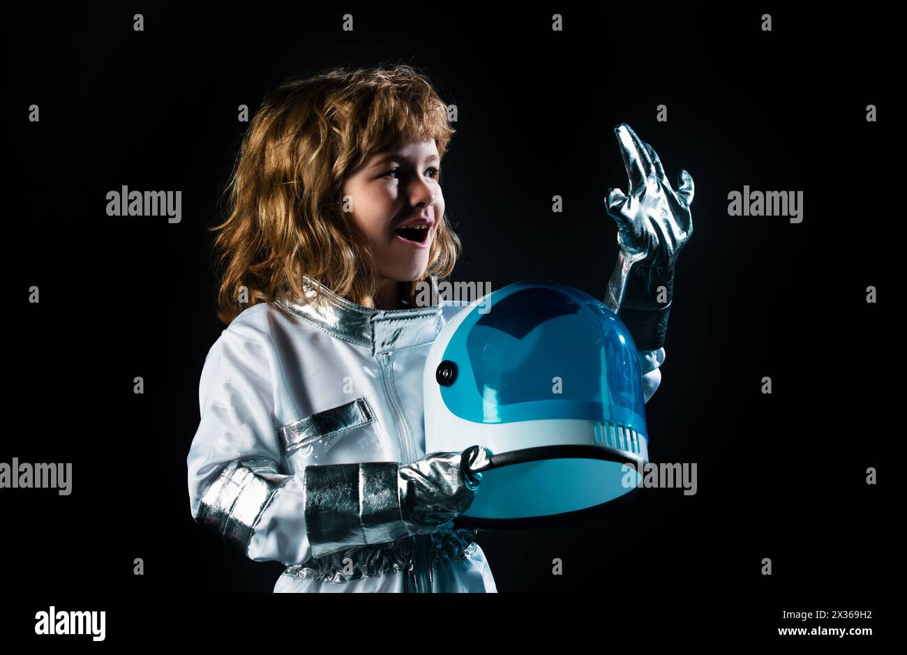 Child boy is dressed in an astronaut costume on black isolated ...