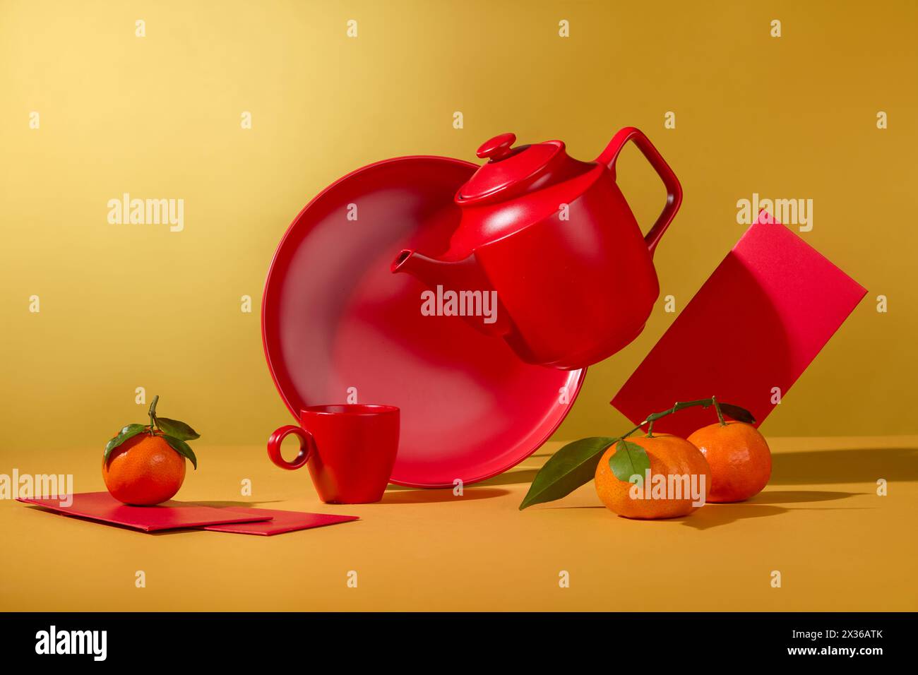 Over yellow background, a tea set in red color decorated with ...