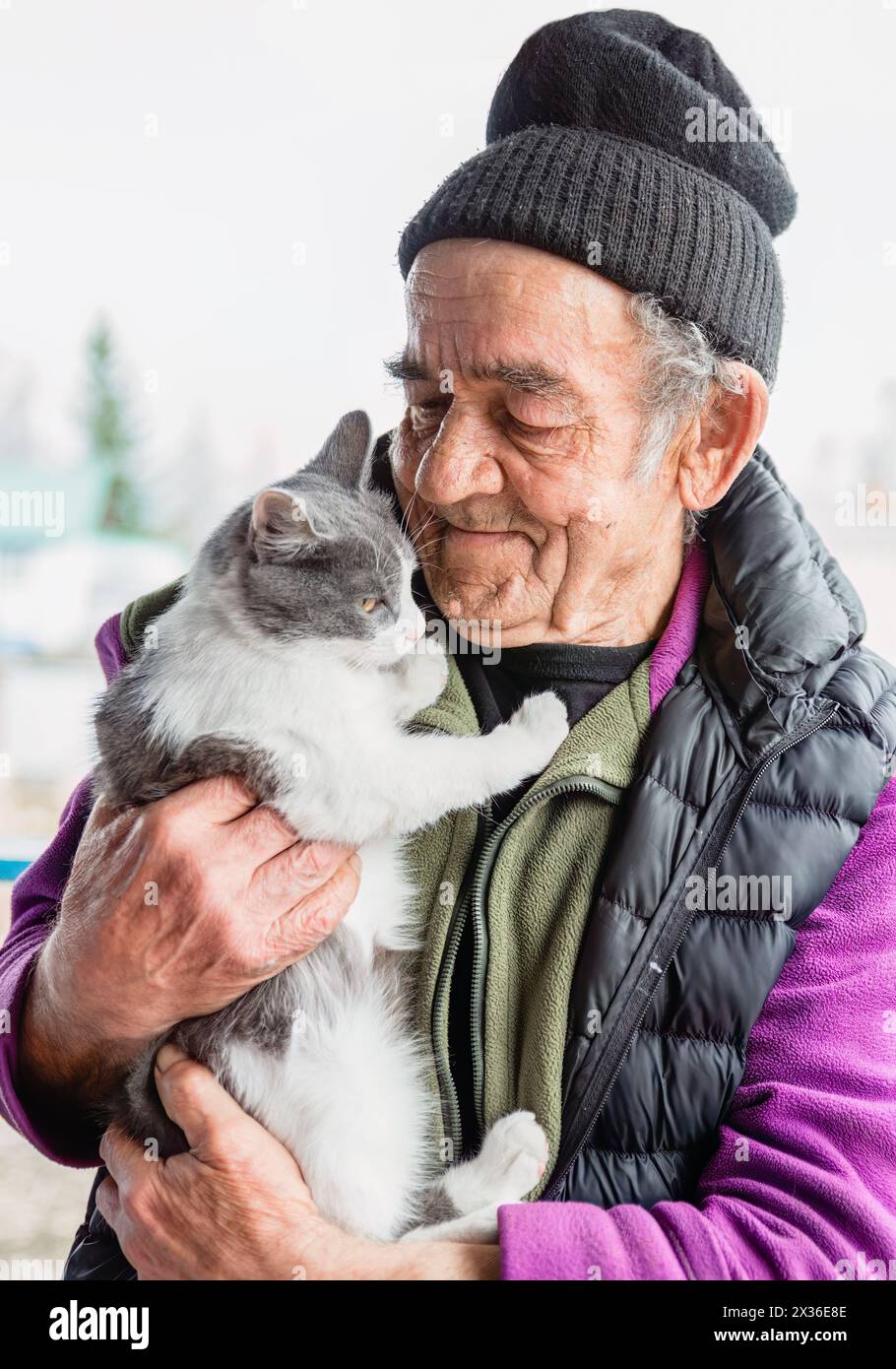Old Russian man holding his cat and smiling Stock Photo - Alamy
