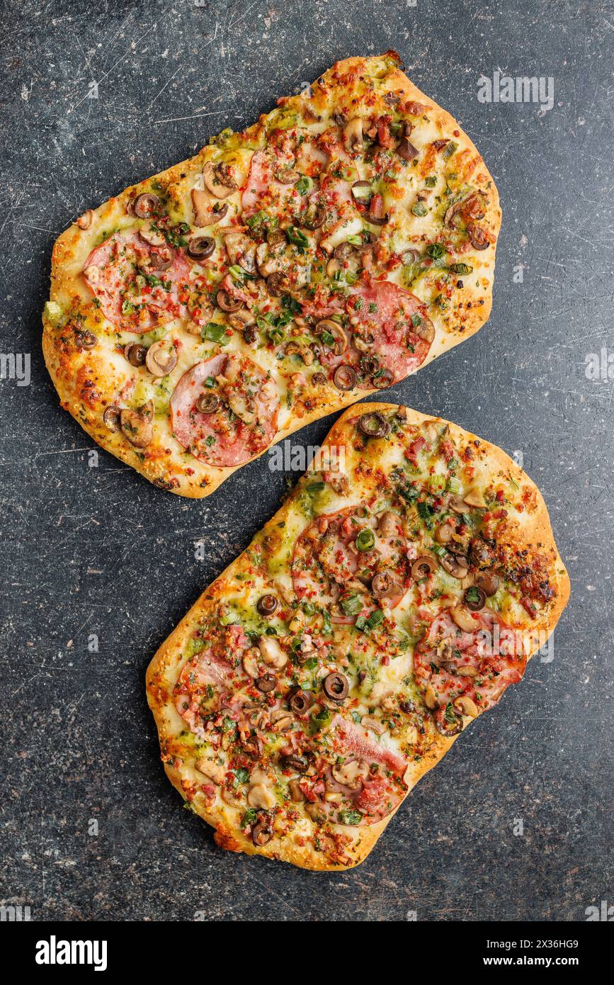 Tasty italian square pizza on a kitchen table. Top view Stock Photo - Alamy