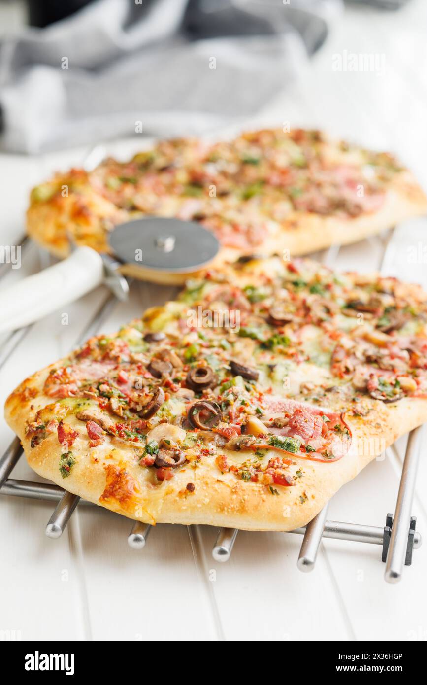 Tasty italian square pizza on a kitchen table Stock Photo - Alamy