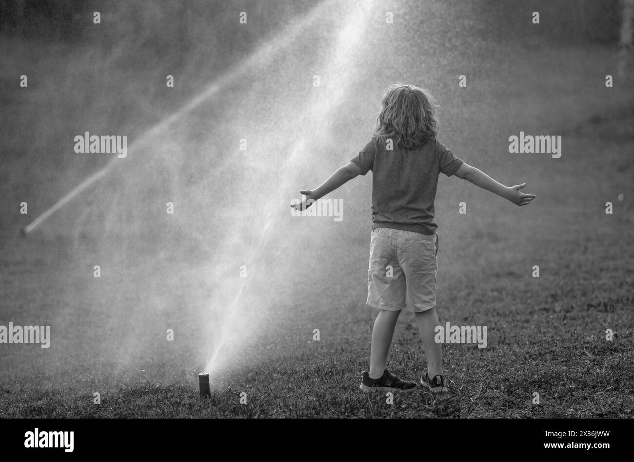 Cute little kid play in garden at summer day. Child enjoy summer in ...