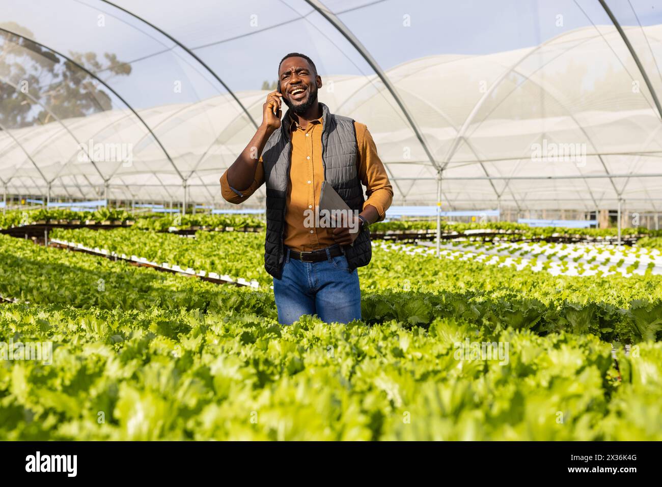 Happy young farmer walking through hi-res stock photography and images ...