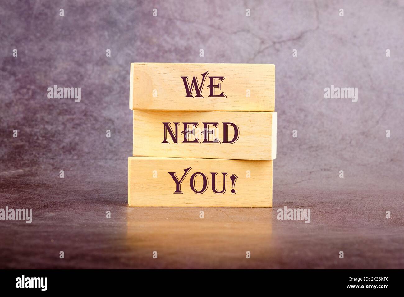 We Need You Message Concept written on wooden blocks on a dark ...
