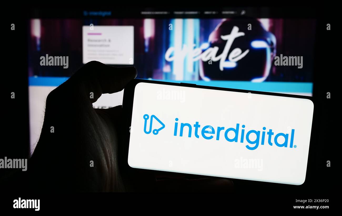 Person holding mobile phone with logo of American technology company ...