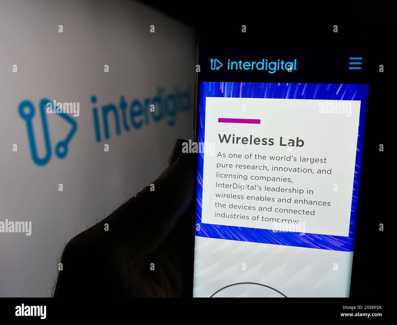 Person holding cellphone with webpage of US technology company ...