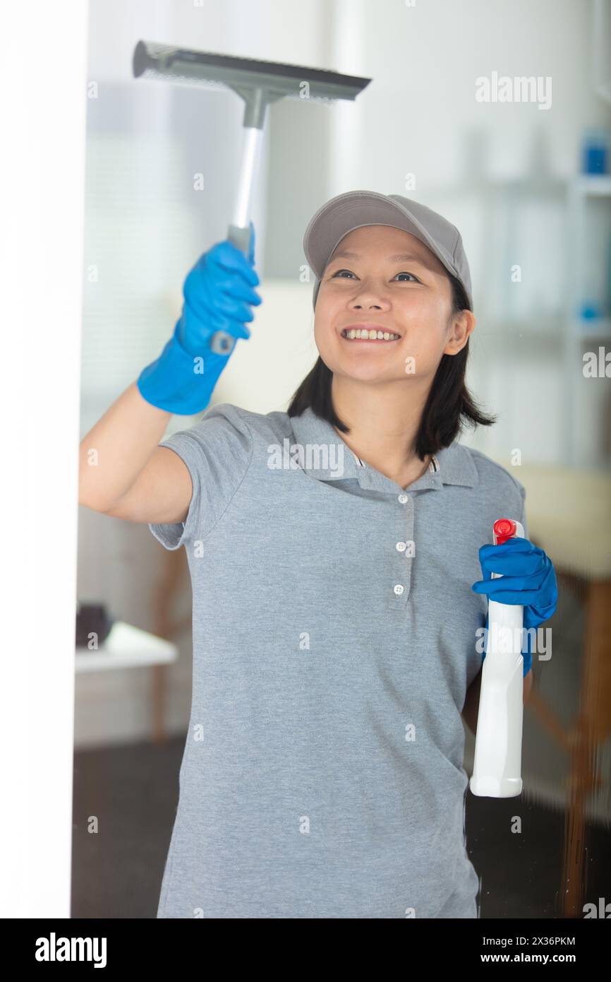 happy woman is cleaning a fake window Stock Photo - Alamy