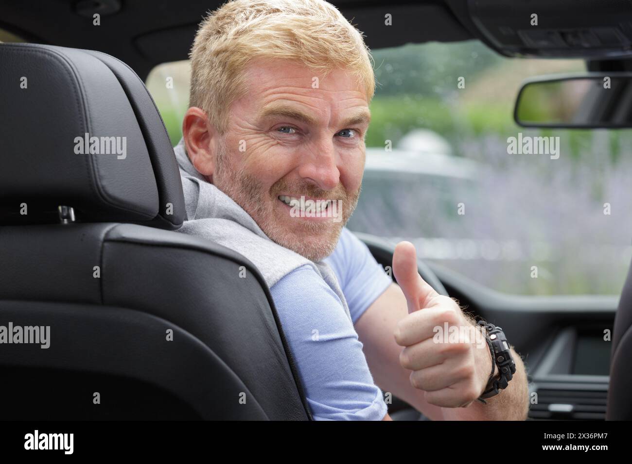 portrait of happy man showing thumbs up while driving van Stock Photo ...