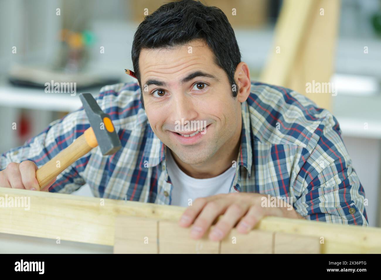 happy worker with a hammer on his shoulder Stock Photo - Alamy