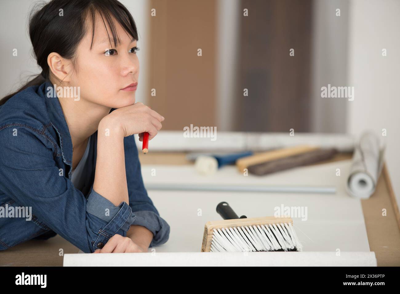 asian woman carpenter thinking in her office Stock Photo - Alamy