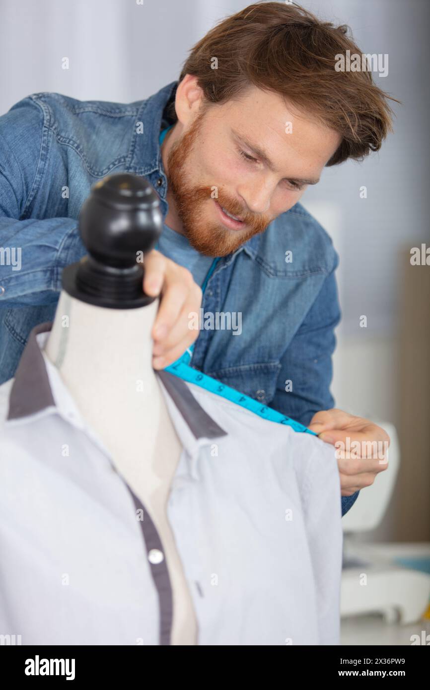 bearded male dressmaker measure fitting cloth on mock-up Stock Photo ...