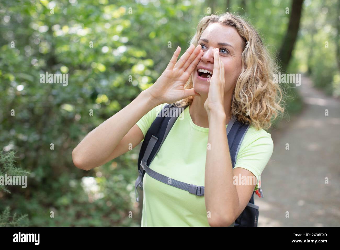 attractive hiker girl screaming in the forest Stock Photo - Alamy