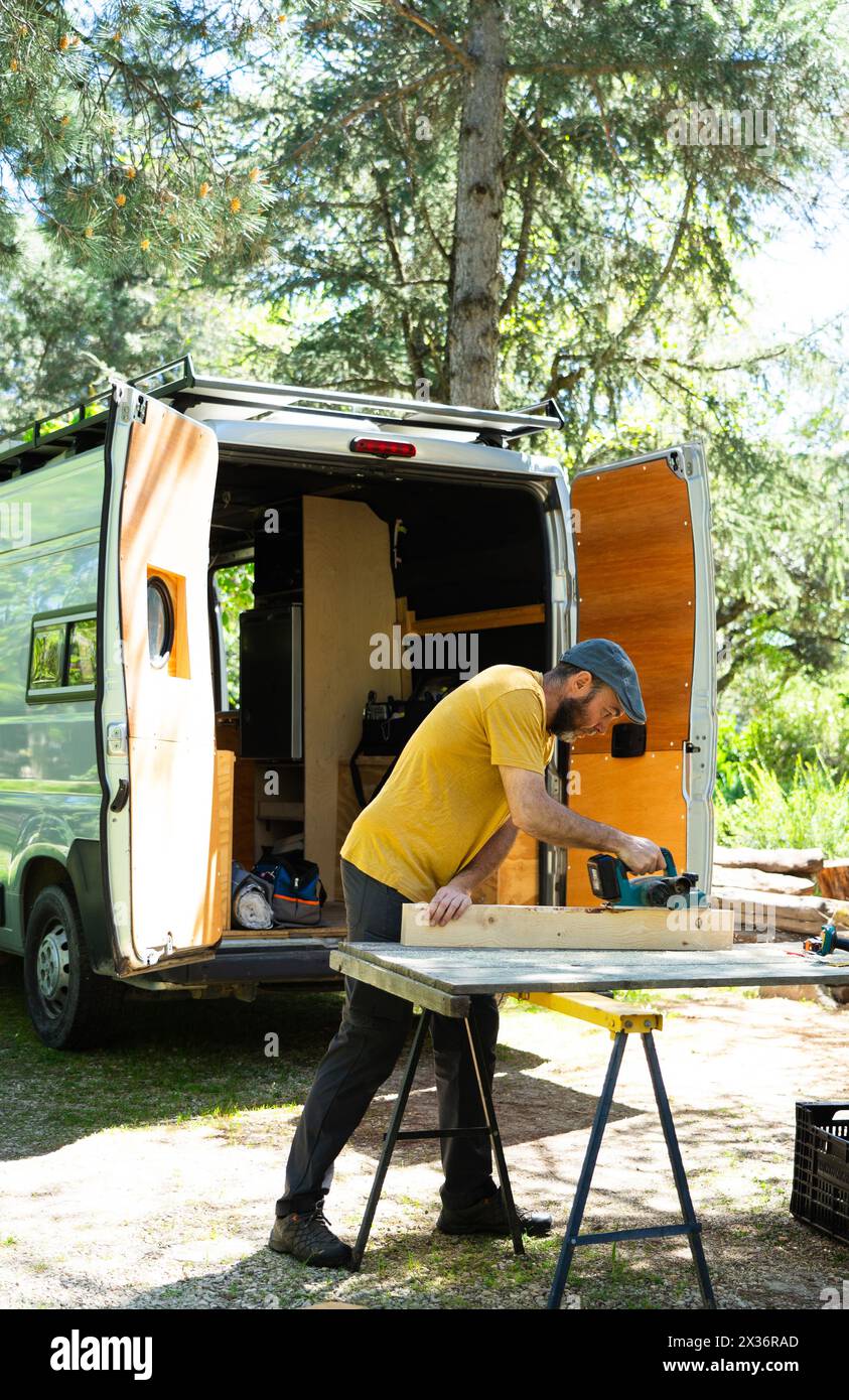 Man working with wood to camper a van Stock Photo - Alamy