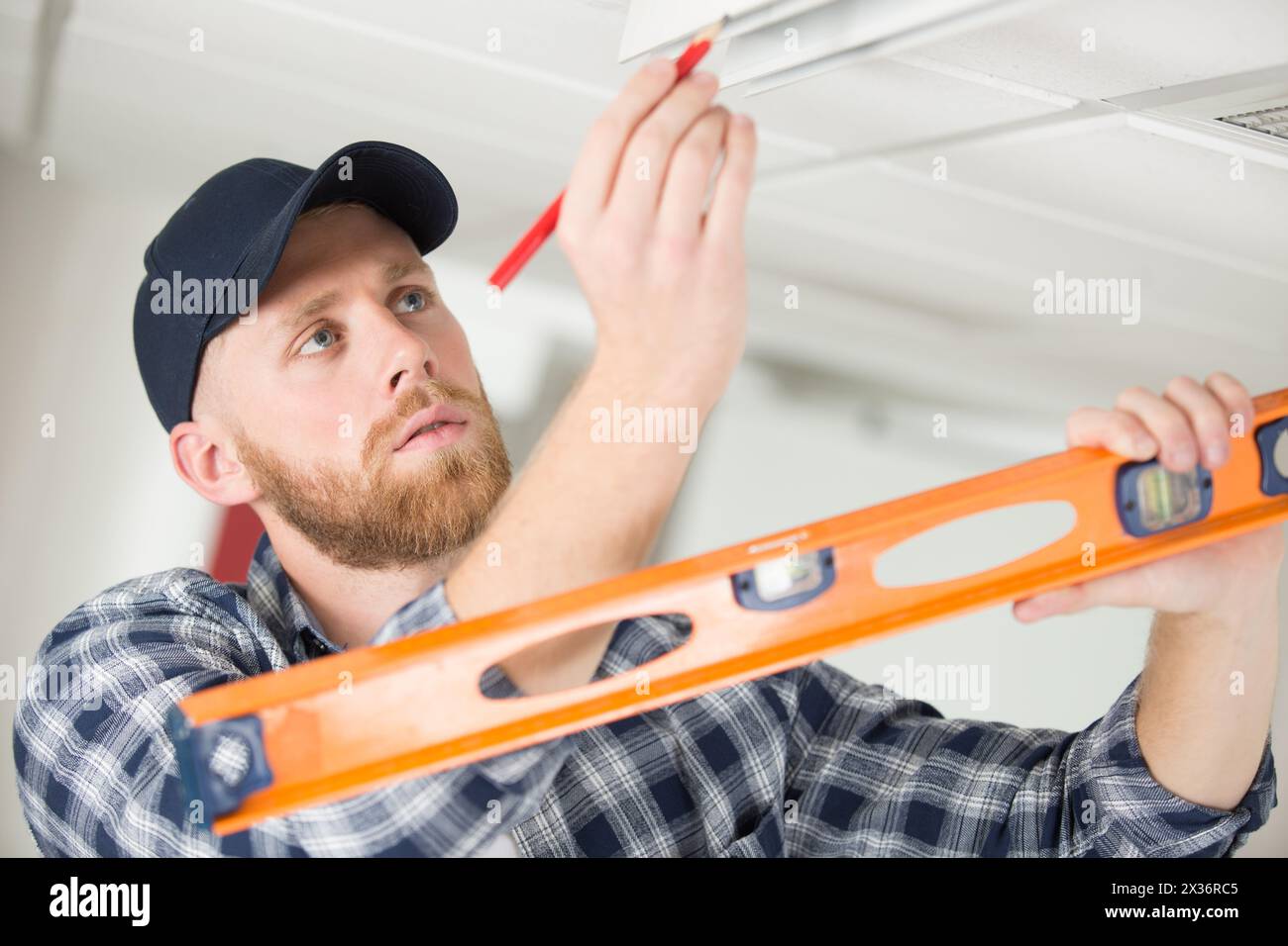 taking ceiling measures with spirit level Stock Photo - Alamy
