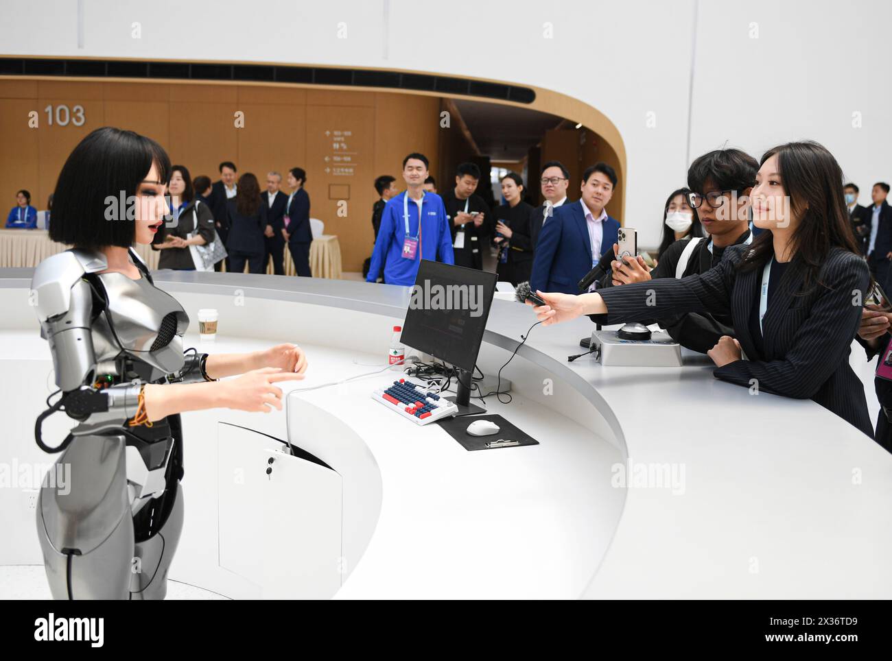 Beijing, China. 24th Apr, 2024. Journalists interact with a bionic humanoid robot at the ...