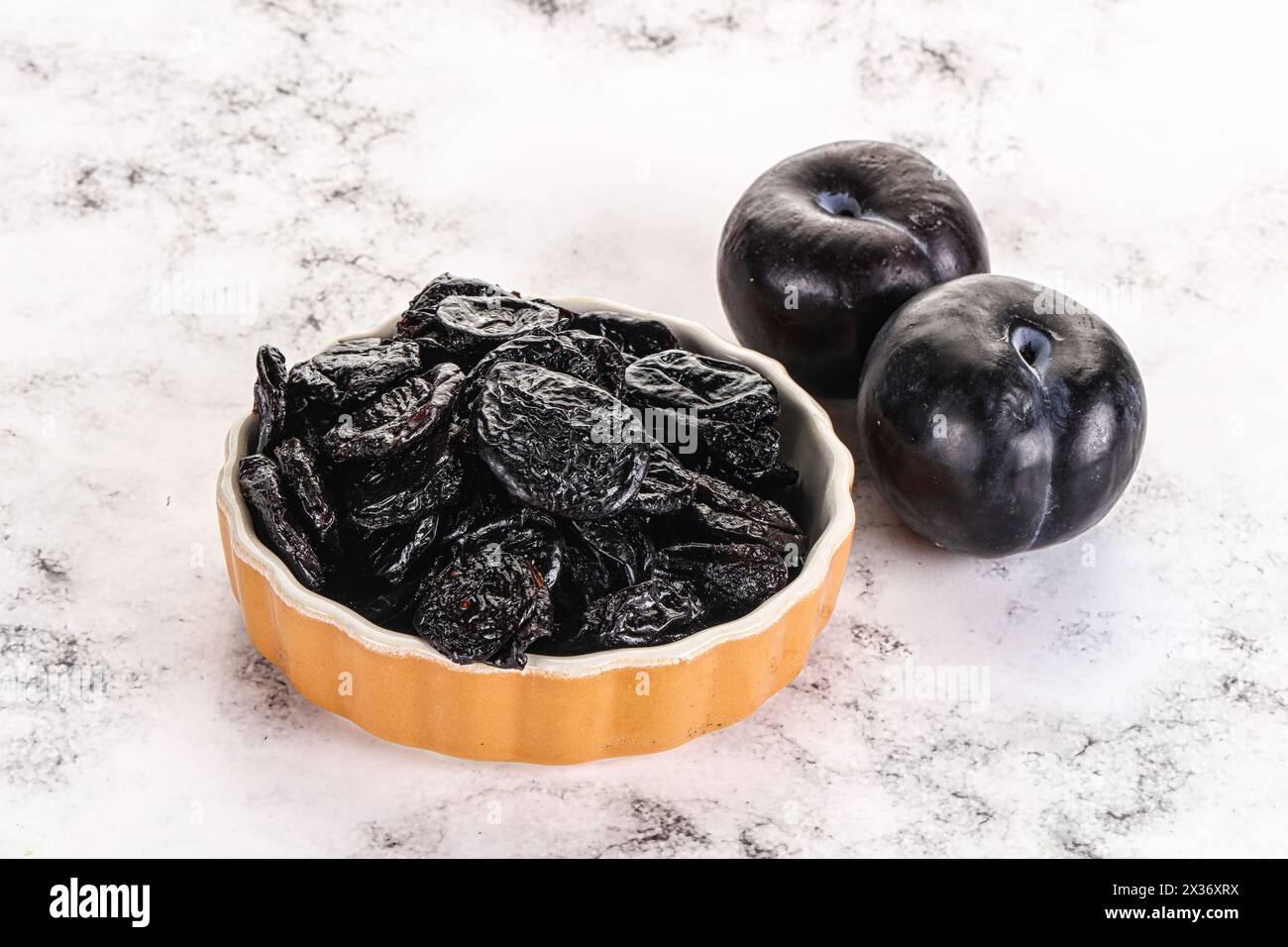 Dry sweet prunes in thw bowl Stock Photo - Alamy