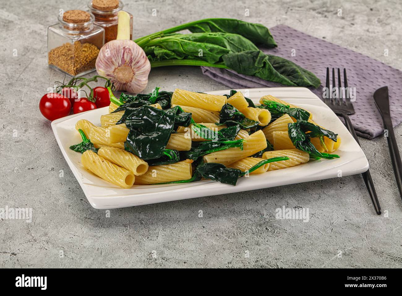Italian cuisine - pasta tortiglioni with spinach Stock Photo - Alamy