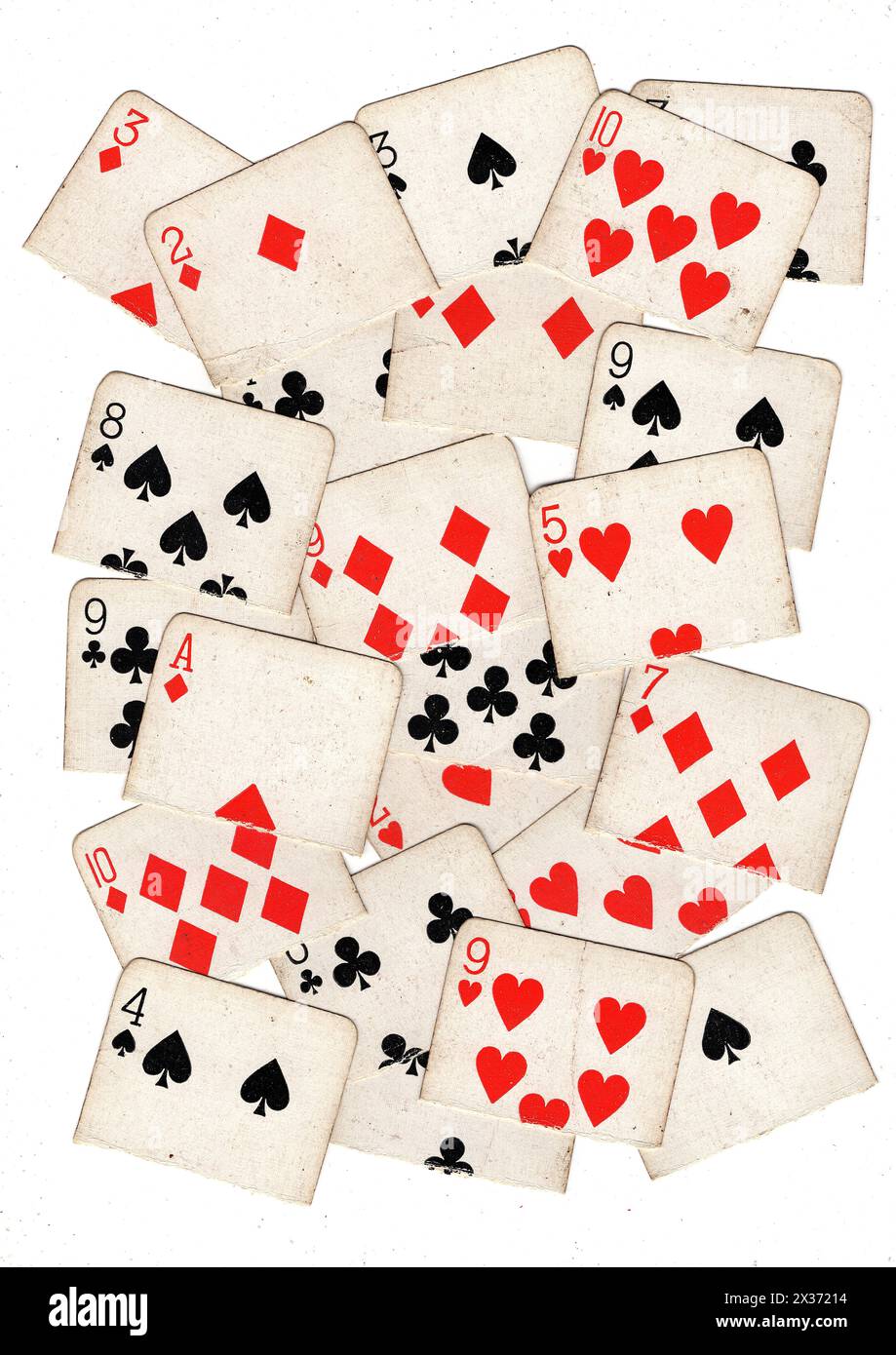 A montage of vintage playing cards torn in half on a white background ...