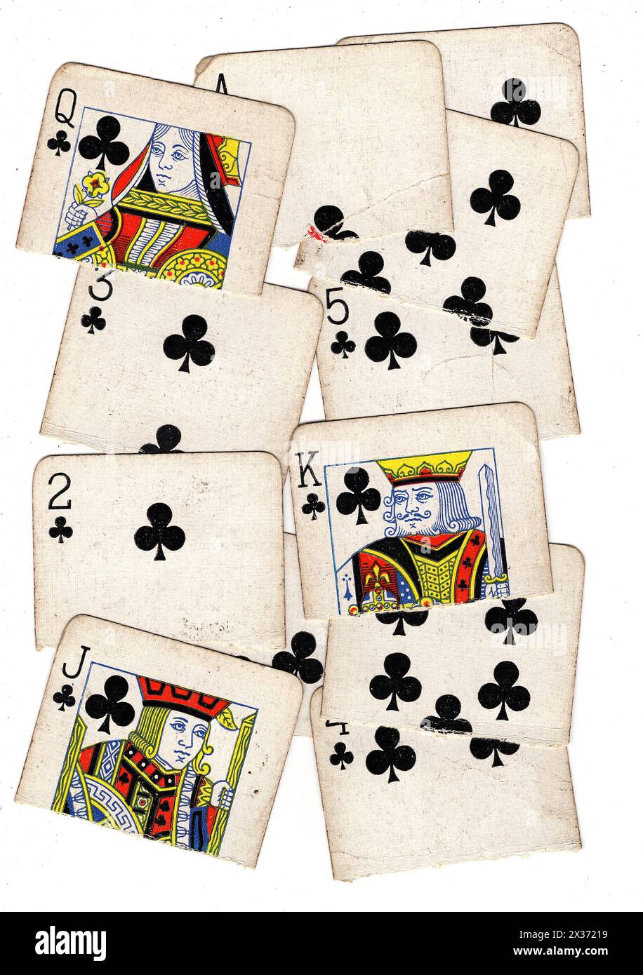 A montage of vintage clubs playing cards torn in half on a white ...