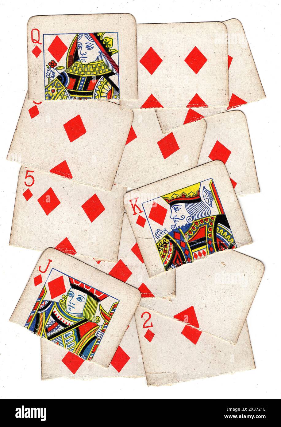 A montage of vintage diamonds playing cards torn in half on a white ...
