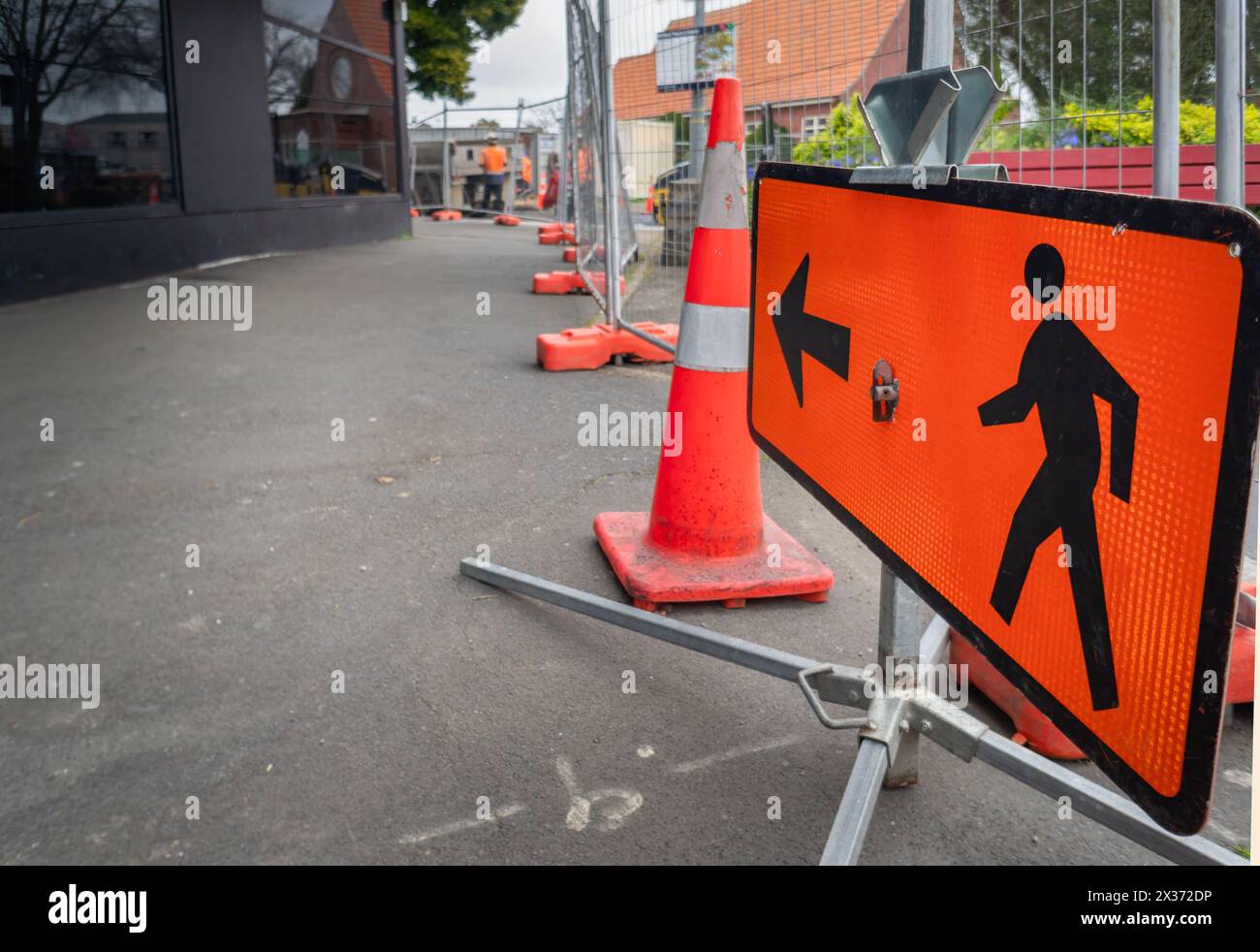 Man Walking Road sign along a closed footpath. Unrecognizable workers ...