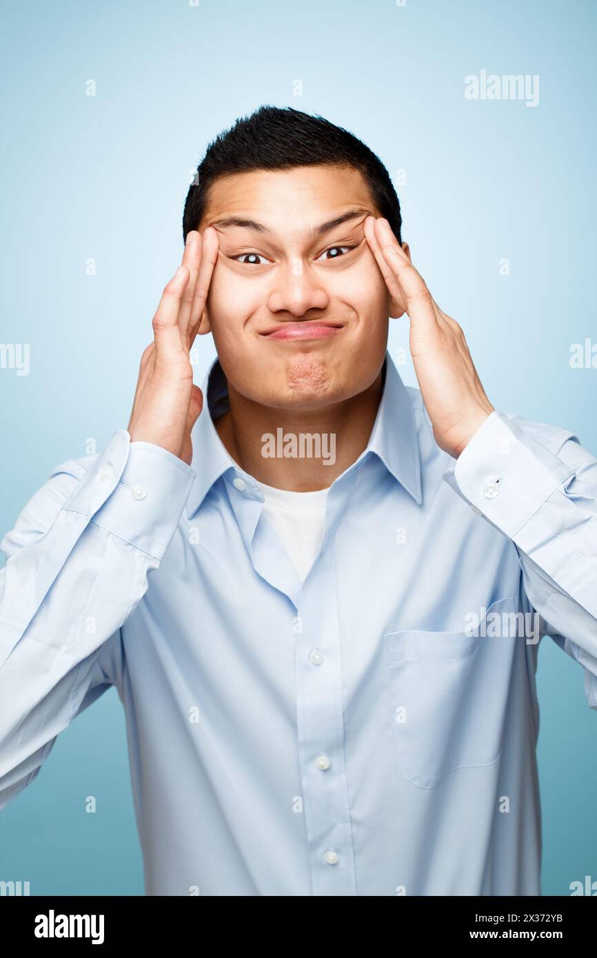 Funny face, goofy and portrait of silly man in studio isolated on blue ...