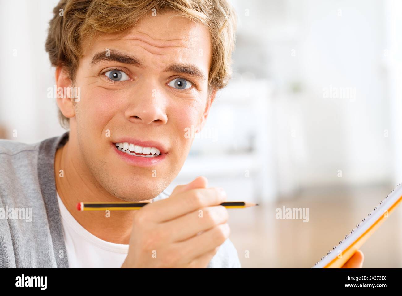 Portrait, confused and man writing notes in classroom for studying ...