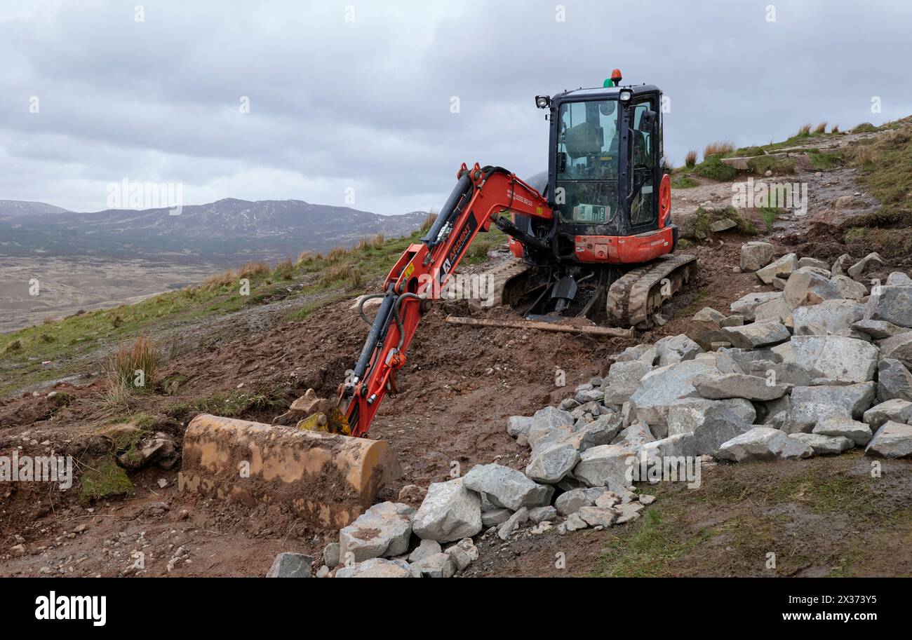 Excavator used for digging and arranging stones to form new, hard ...