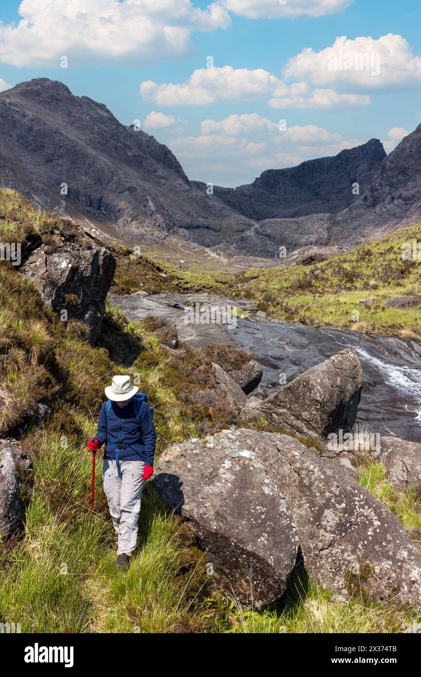Lone female hill-walker descending from the corrie of Coire Lagan in ...