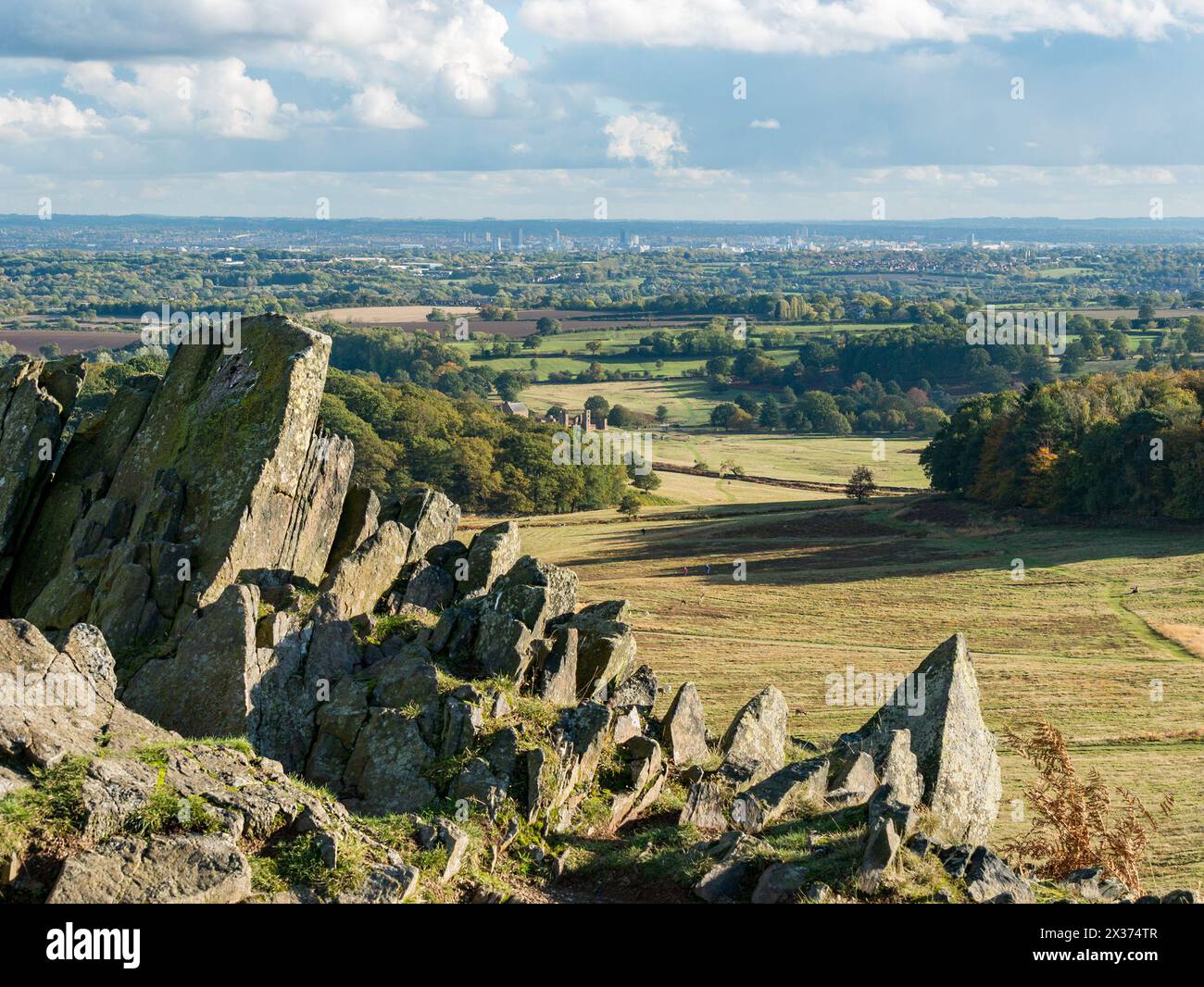 The city of Leicester in the distance as seen from a rocky countryside ...