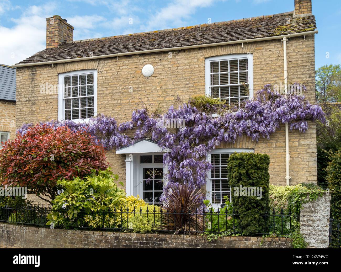 Attractive, old (c 1826) stone cottage house with climbing wisteria in ...
