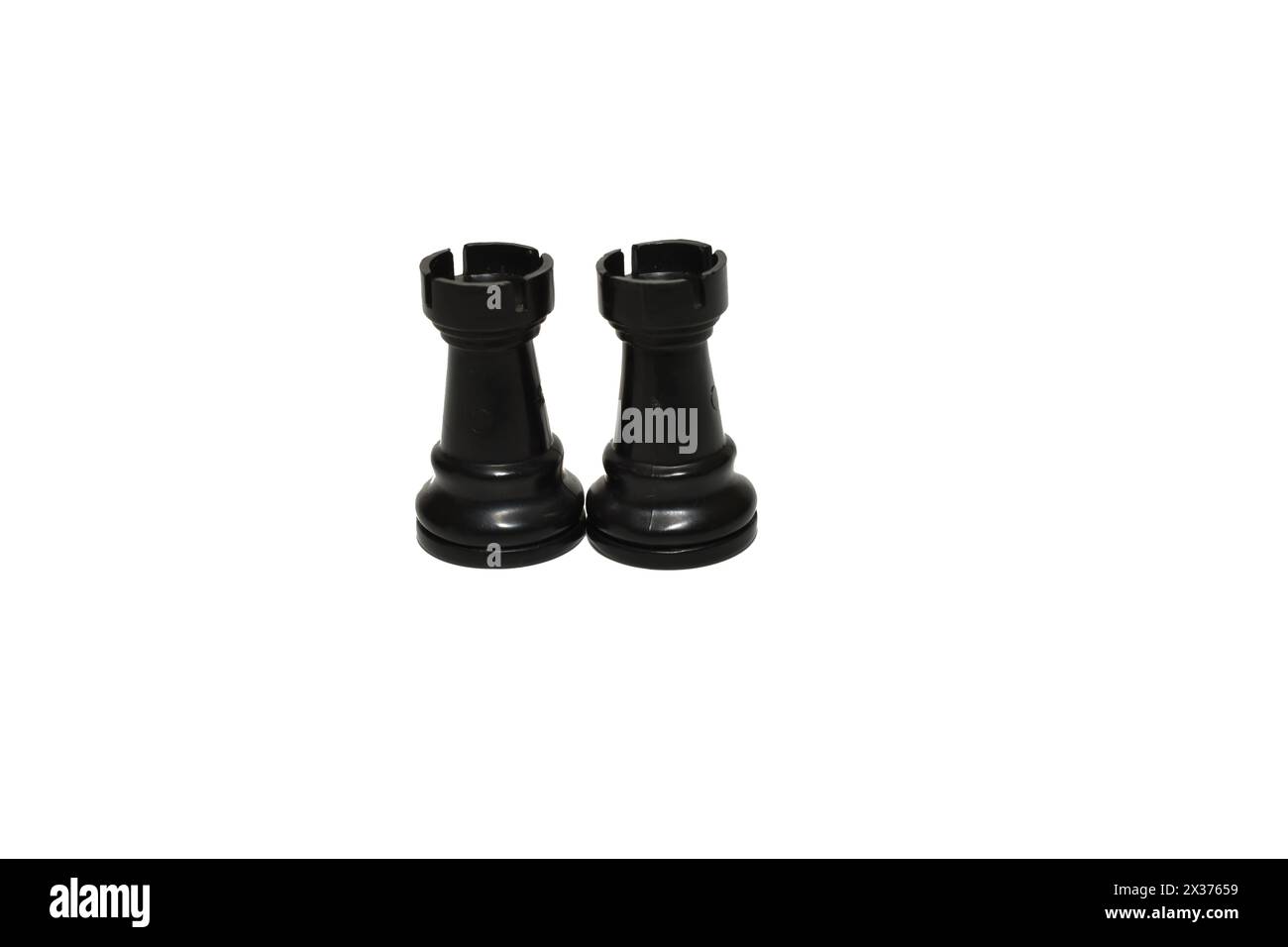 On a white background there are two black chess pieces called a round ...