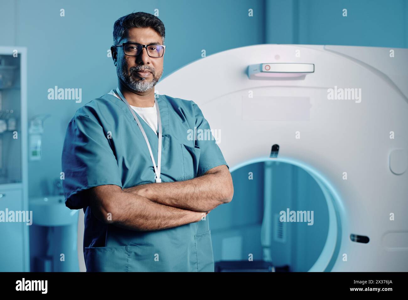 Portrait of professional doctor adjusting MRI scanner settings for next ...