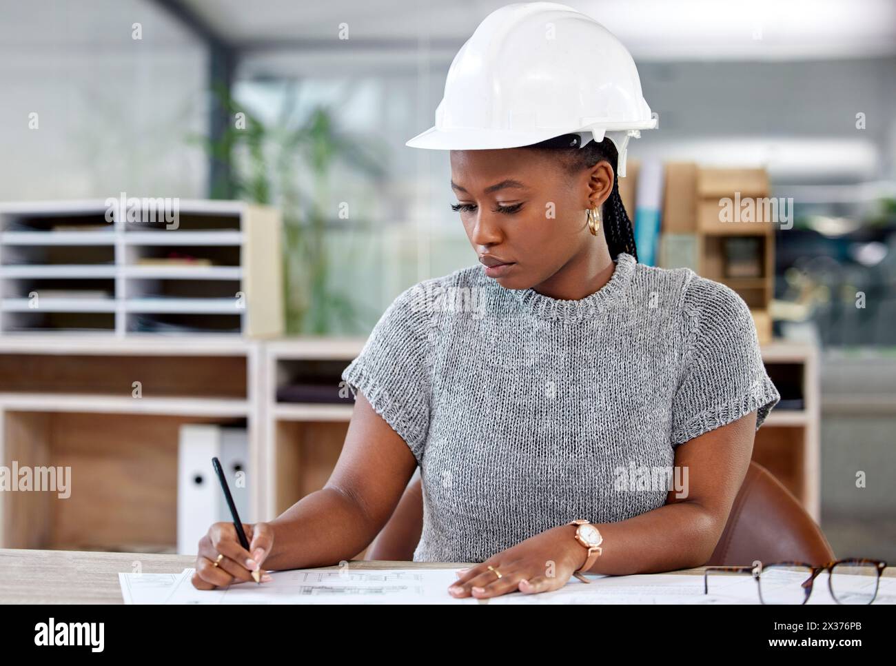 Hardhat, architecture and black woman drawing blueprint in office for ...