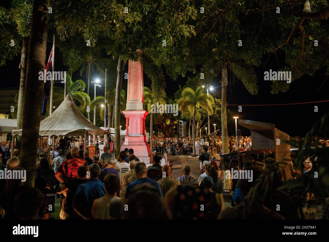 People stand at the Cairns Cenotaph during the ANZAC Day dawn service ...
