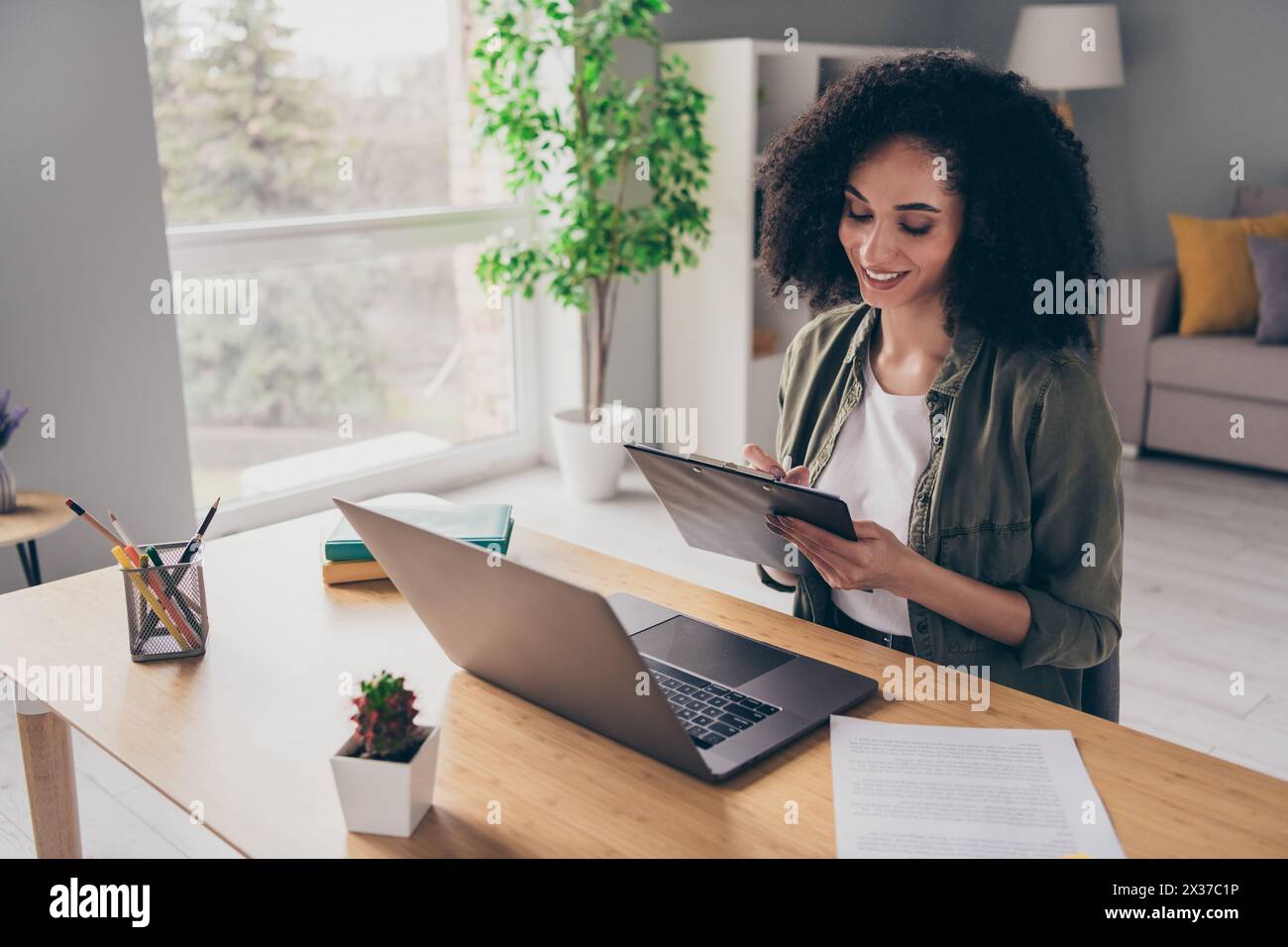 Photo of positive charming lady assistant dressed shirt signing papers ...