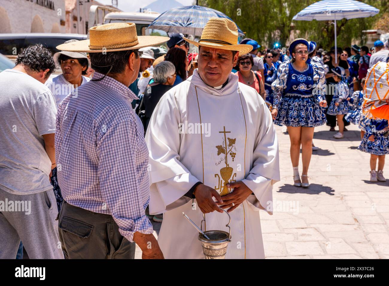 A Catholic Priest Talks To People In The Crowd During La Fiesta de la ...