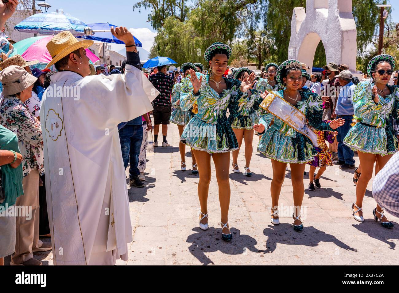 A Catholic Priest Blesses A Group of Female Dancers At La Fiesta de la ...