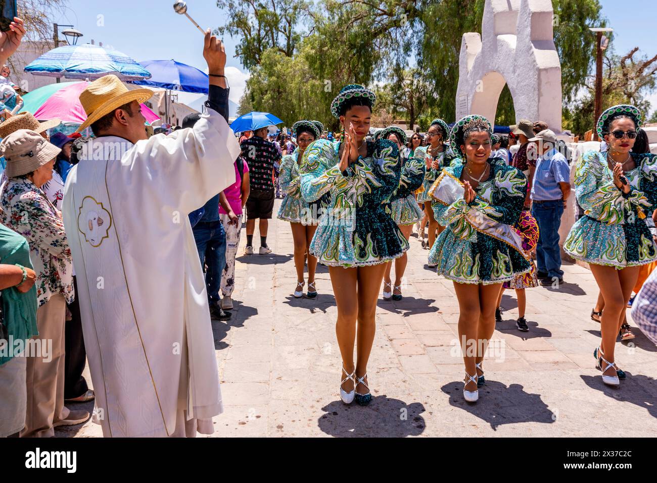 A Catholic Priest Blesses A Group of Female Dancers At La Fiesta de la ...