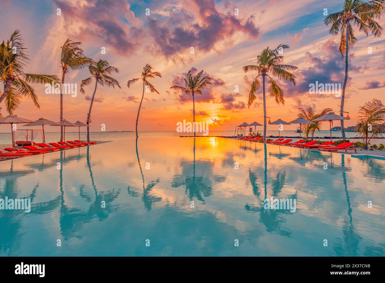 Tropical sunset over outdoor infinity pool summer seaside resort, beach ...