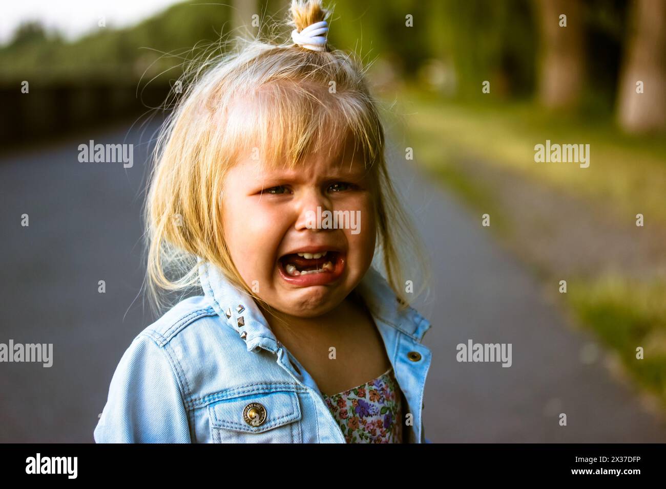 Unhappy child crying loudly with mouth open because of parents' divorce ...