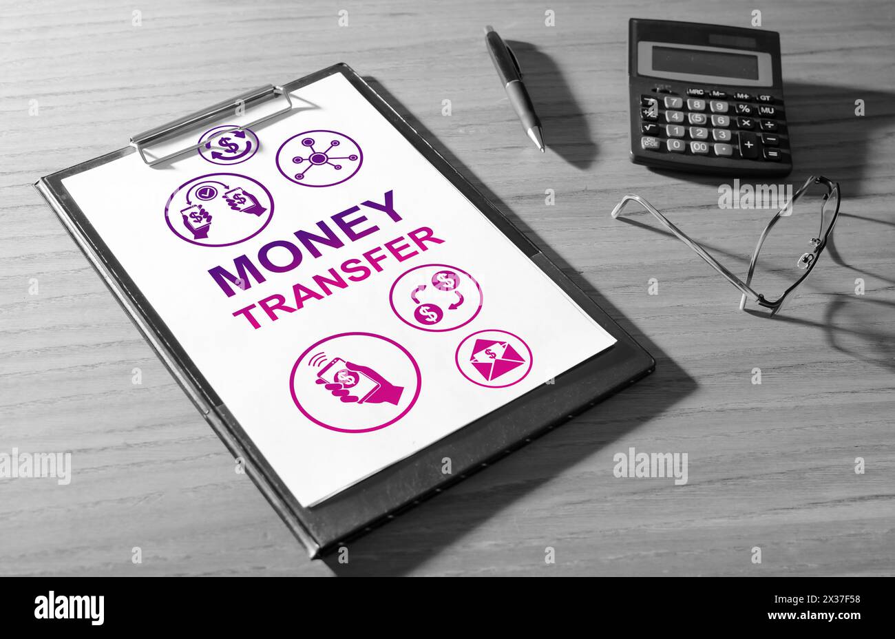 Money transfer concept on a clipboard with a calculator Stock Photo - Alamy