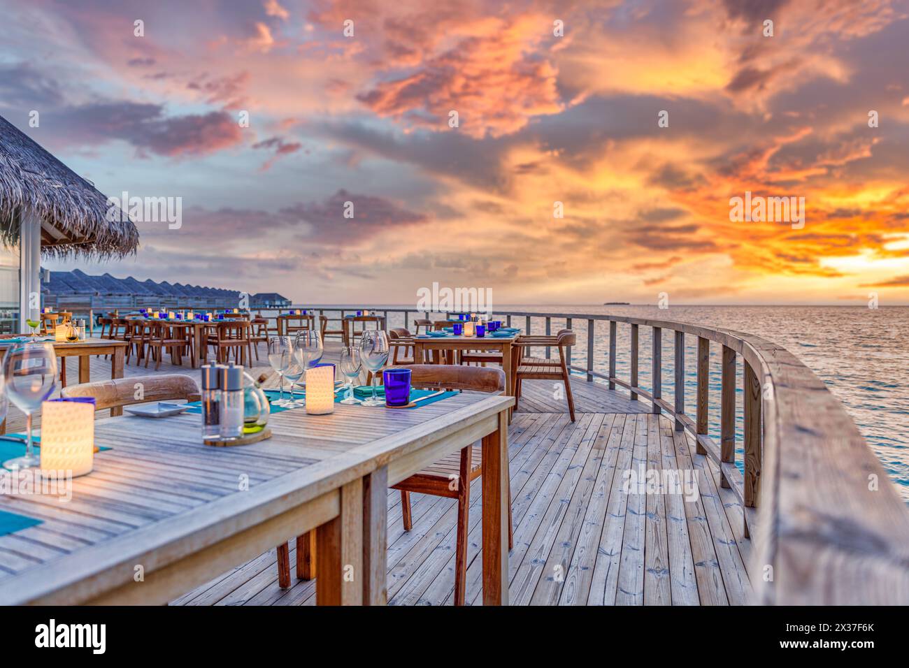 Luxury outdoor restaurant at the beach. Tables at beach restaurant. Led ...
