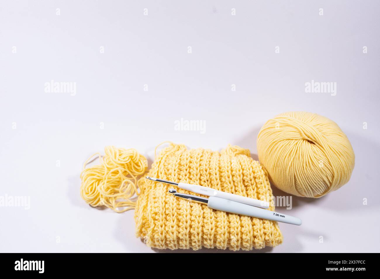 Female hobby knitting. Yellow yarn Stock Photo - Alamy