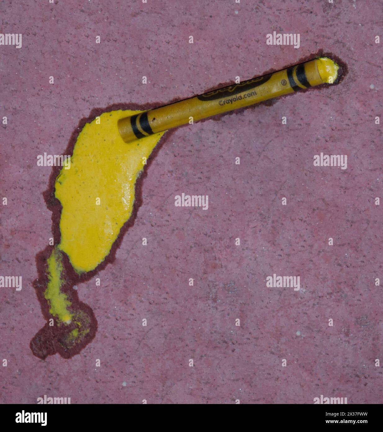 A yellow crayon that has melted from sun and extreme heat Stock Photo ...