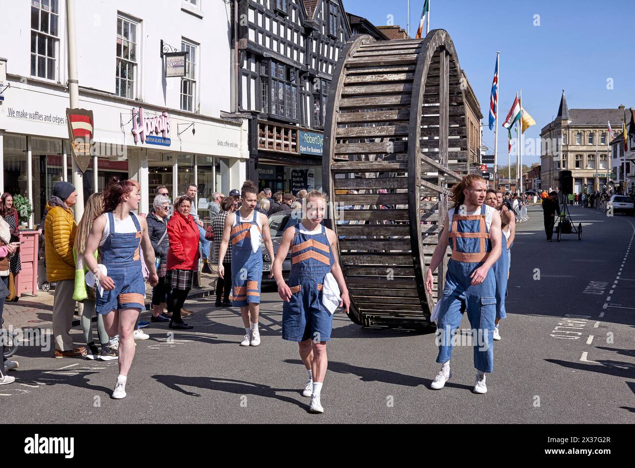Shakespeare celebration parade with acrobats rolling a large wooden ...